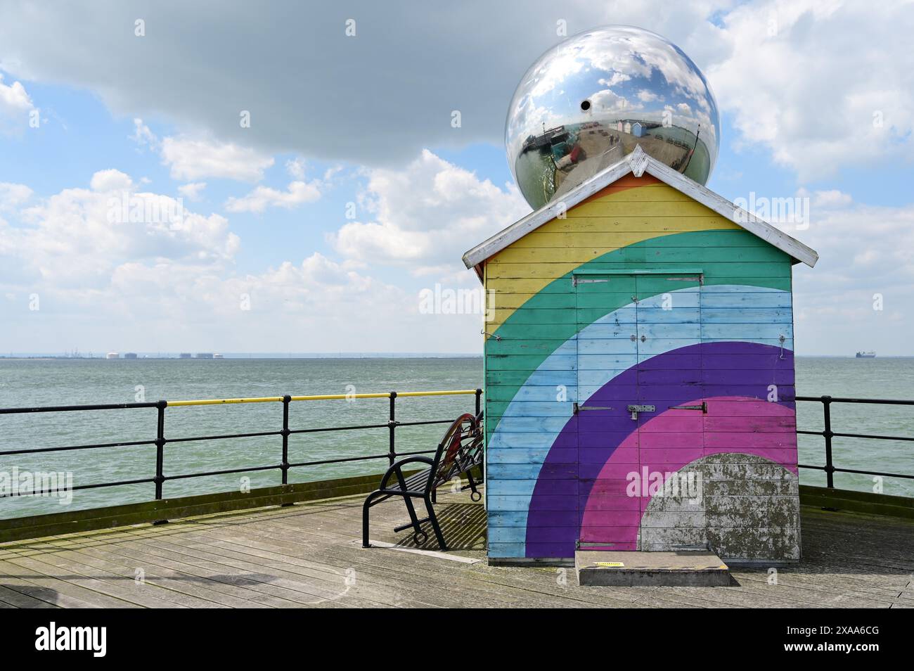 Rainbow coloured shed on a pier on the UK Stock Photo - Alamy