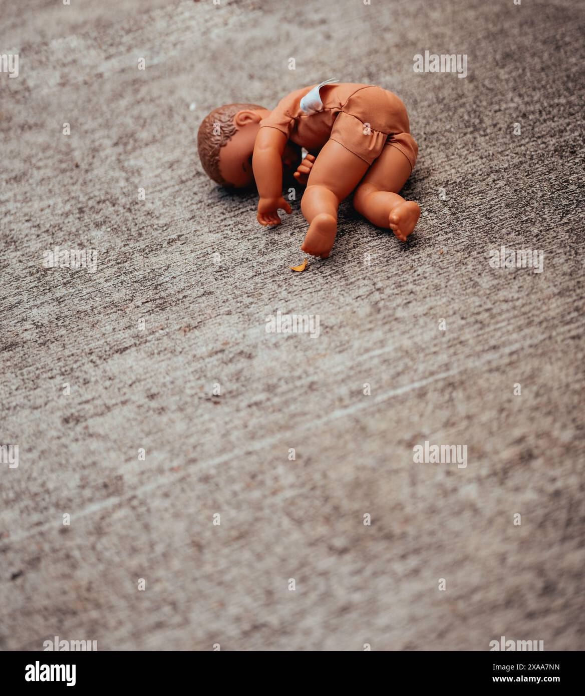 An old doll lying on the floor Stock Photo - Alamy