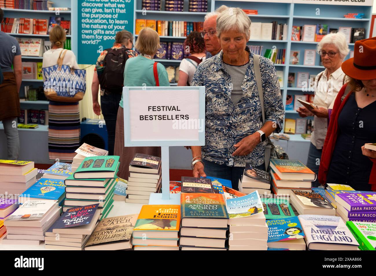 Visitors people older woman looking at bestsellers books on book ...