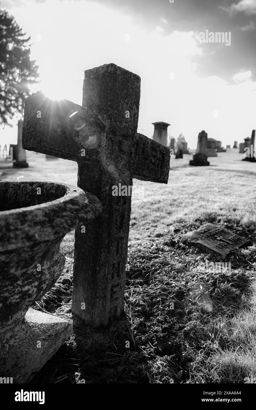 A Sunrise on a cemetery cross marker Stock Photo - Alamy