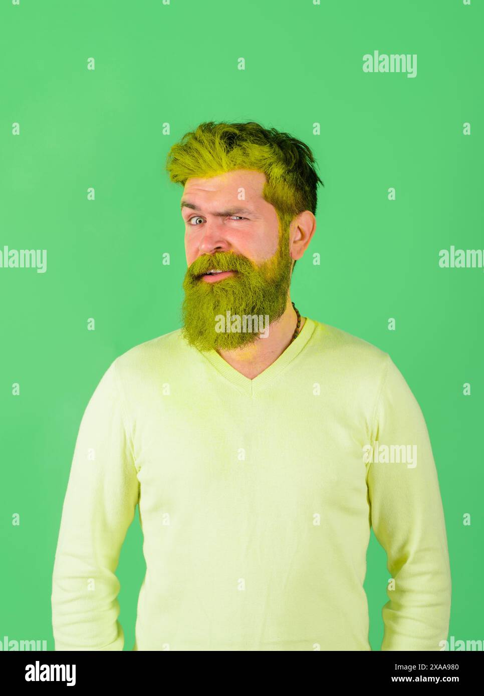 Handsome man in stylish sweater with yellow hair and beard. Hair salon ...