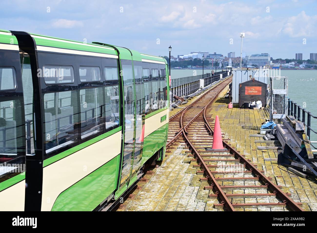 A Train leaving the station at the head of a Pier in the UK Stock Photo ...