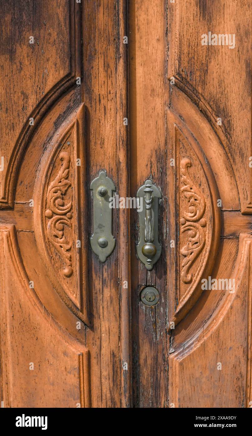 Beautiful embossed wooden door with one of the knockers missing Stock ...