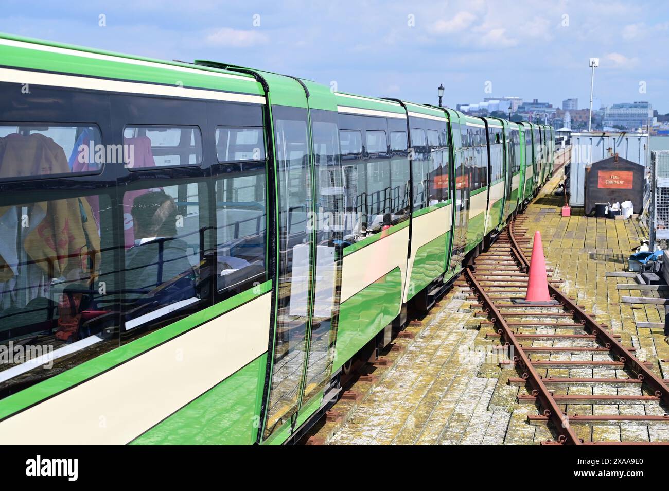 A Train leaving the station at the head of a Pier in the UK Stock Photo ...