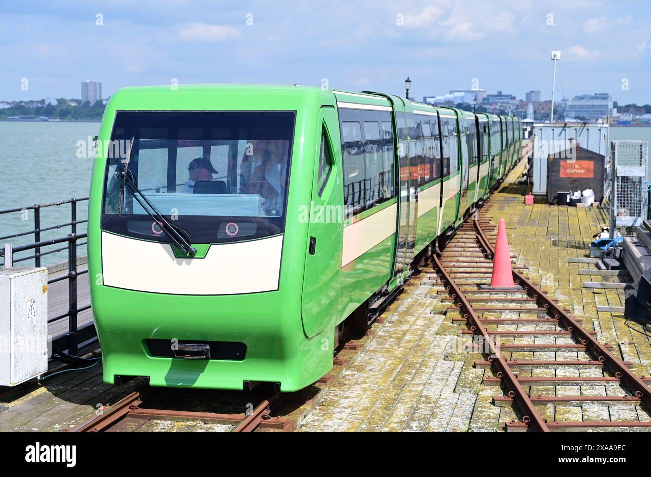 A Train leaving the station at the head of a Pier in the UK Stock Photo ...