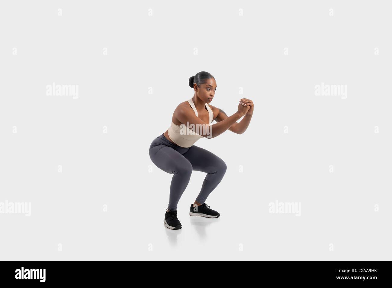 African American Woman Performing Squats During Fitness Workout Stock ...