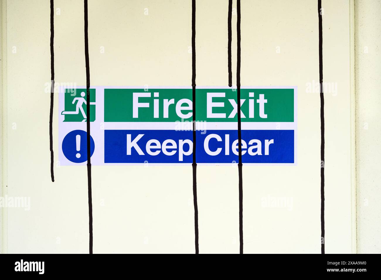 Paint runs over a Fire Exit sign Stock Photo - Alamy