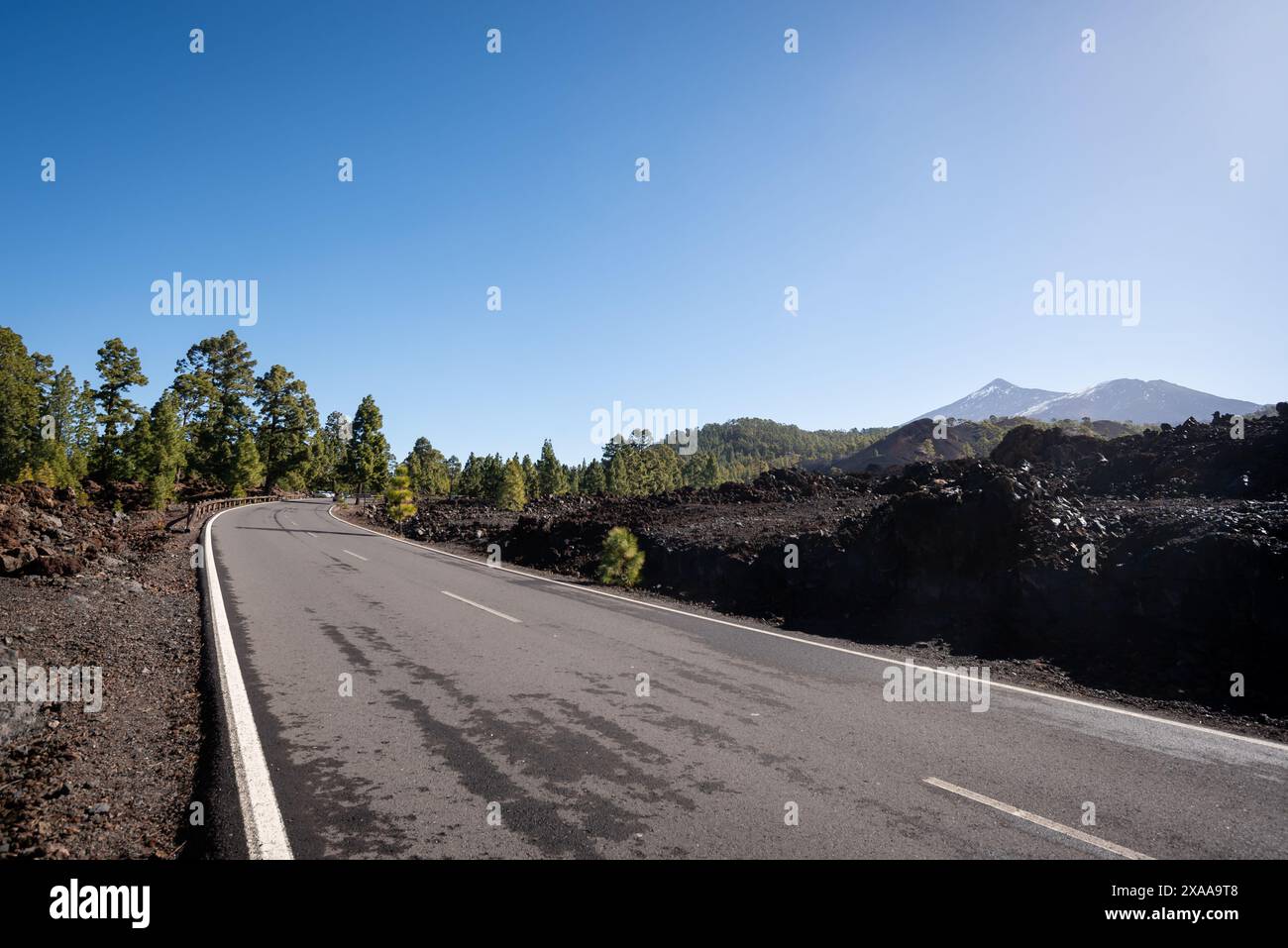 Scenic road beside volcano with lone car driving, travel concept Stock ...