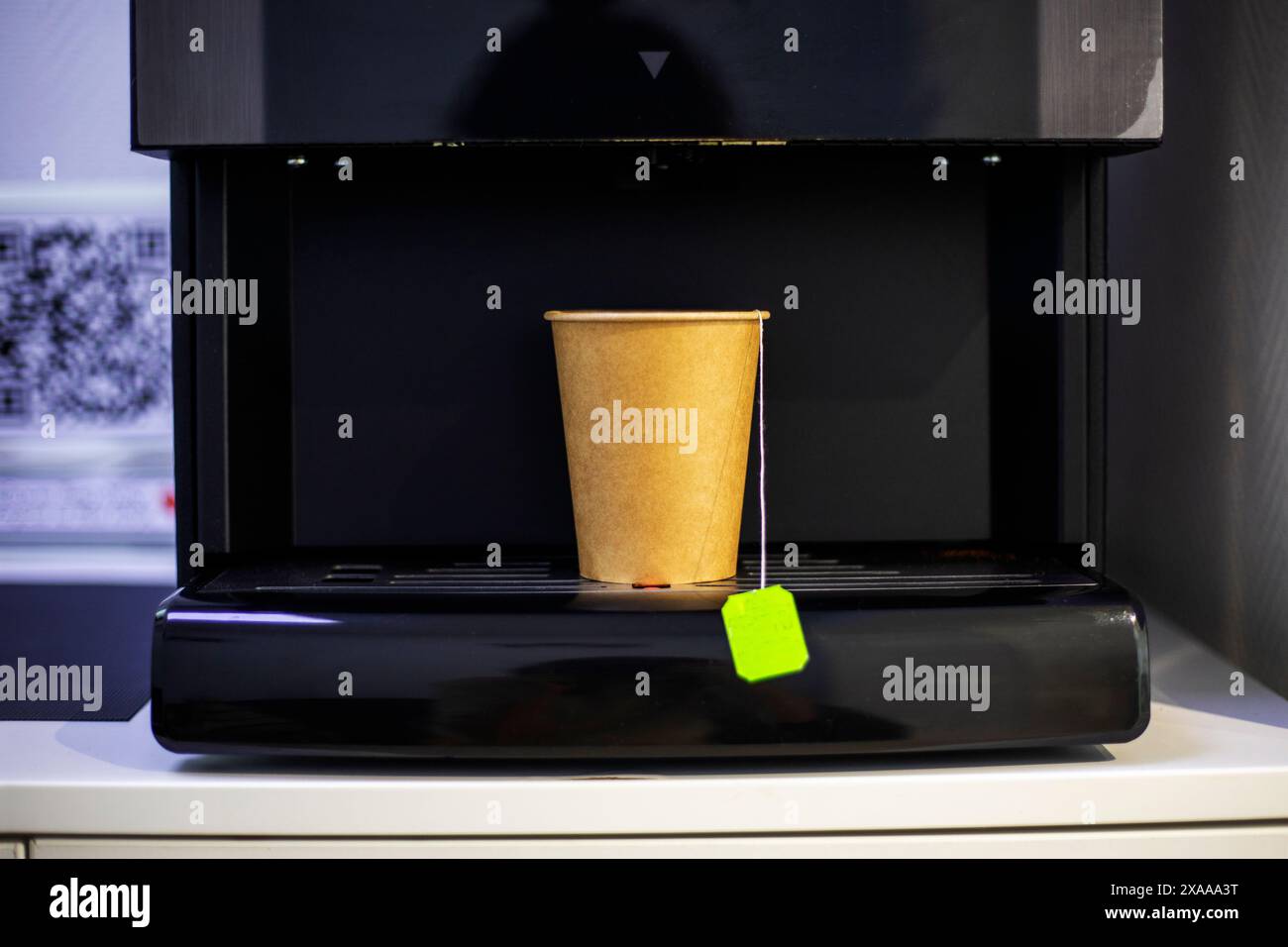 machine with a disposable, recyclable cardboard cup containing a hot ...