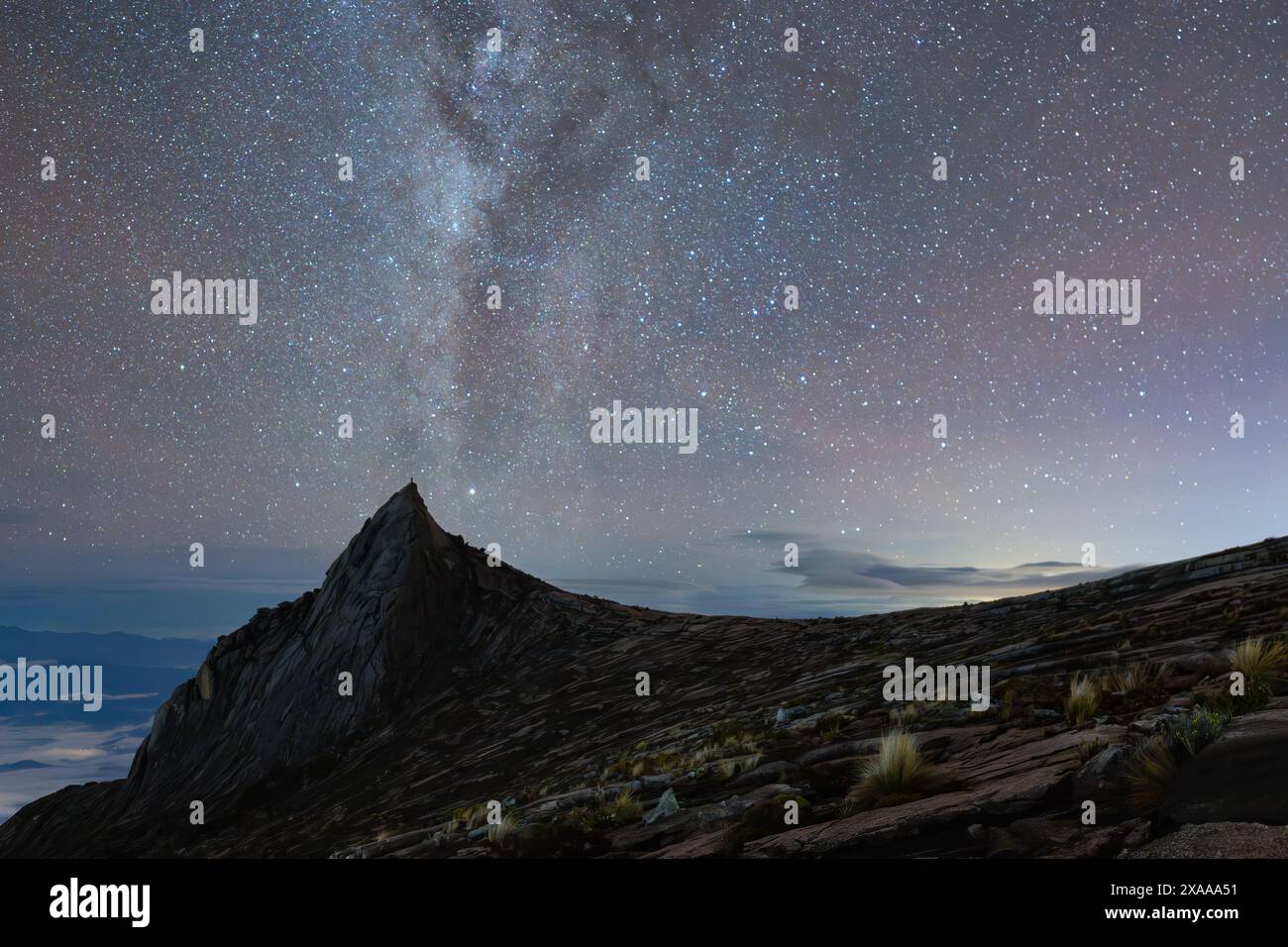 Starry night sky over mountains and hills with milky way shining ...