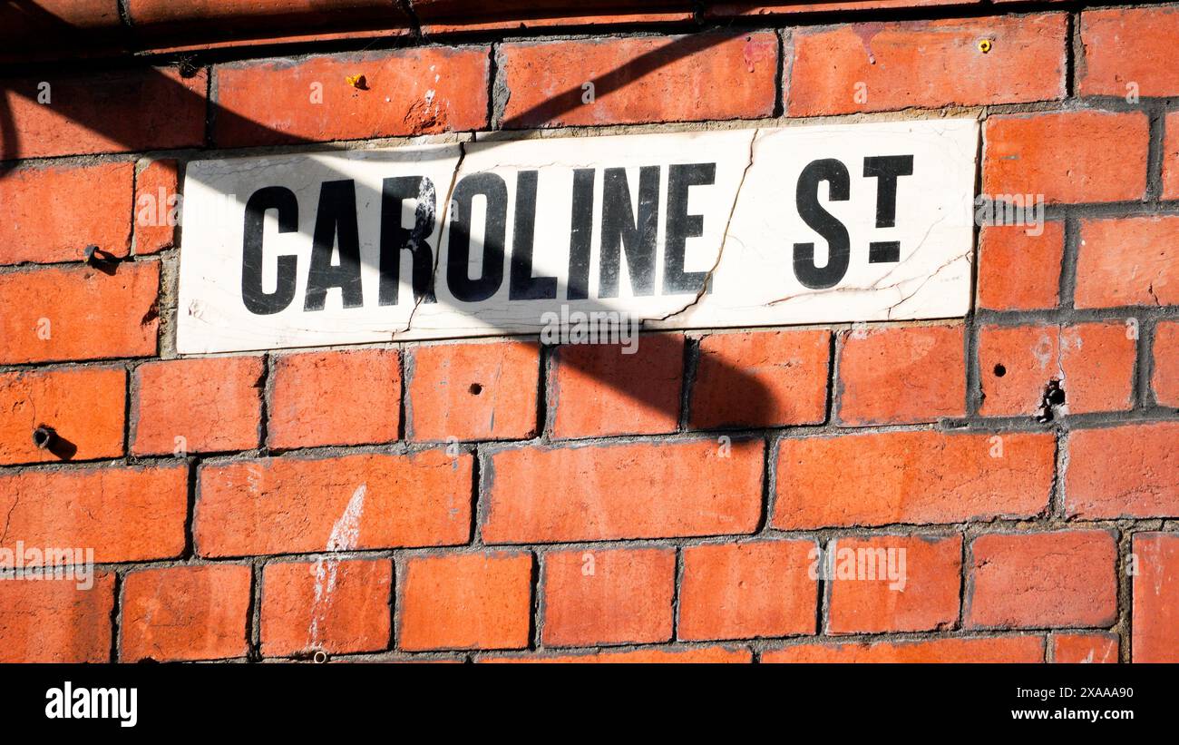 Cardiff, Wales Oct 29 2023: Caroline Street sign on red brick. Also ...