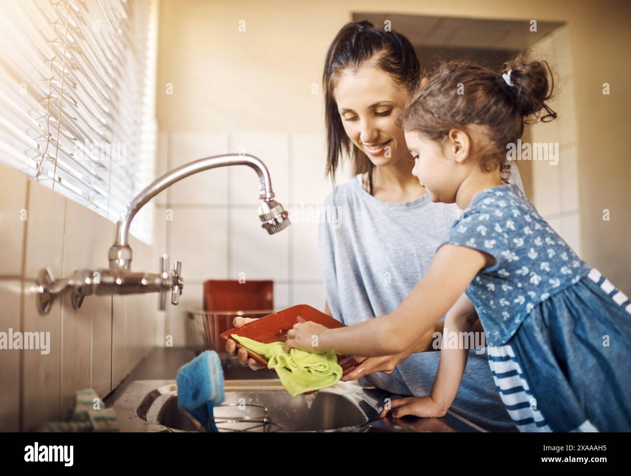 Mom, child and washing dishes in kitchen with cleaning, teaching and ...