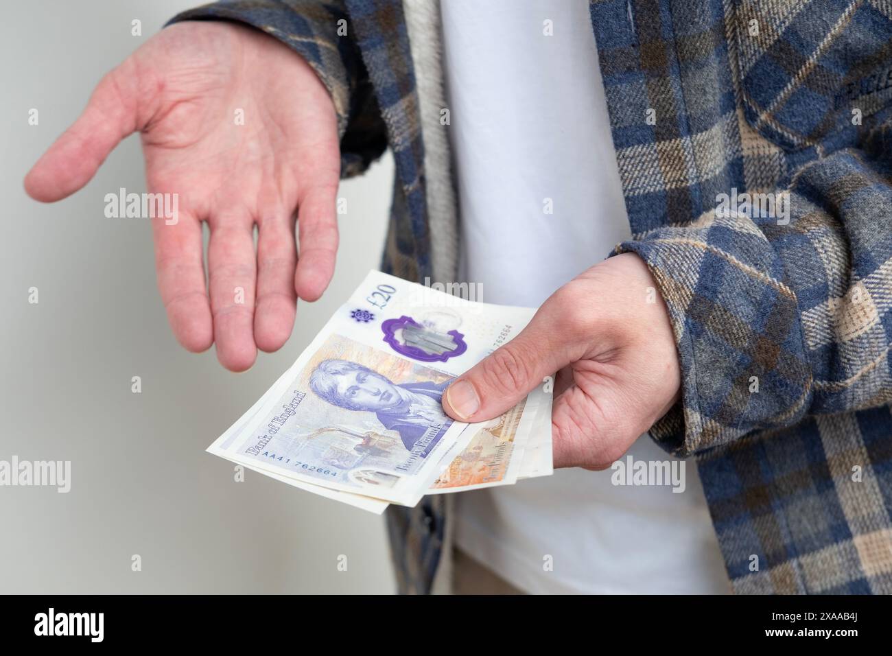 male hands holding money, counting English pound sterling bills ...