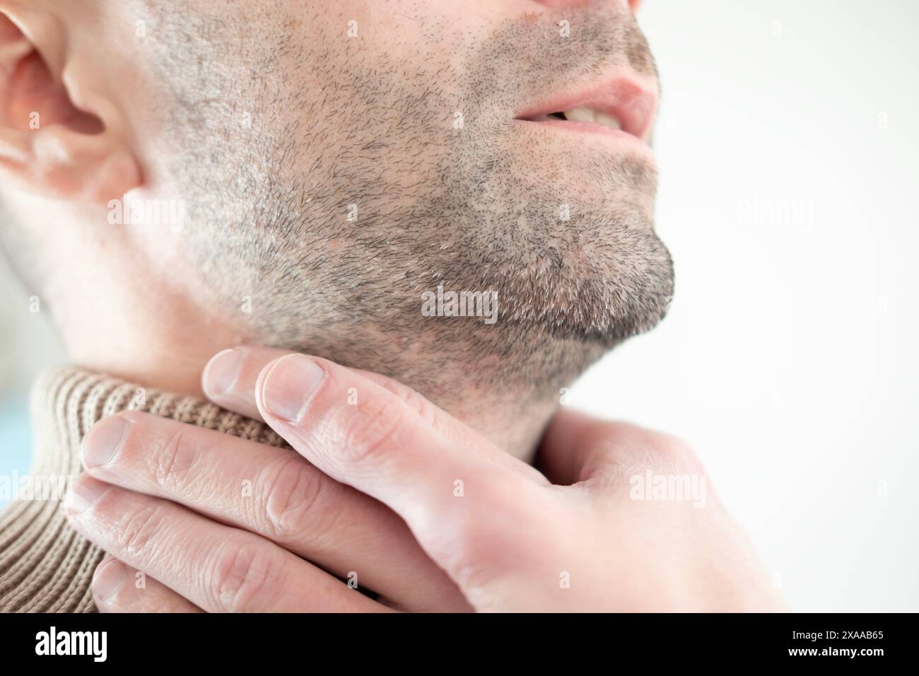 young male neck, man patient holding affected area, experiencing throat ...
