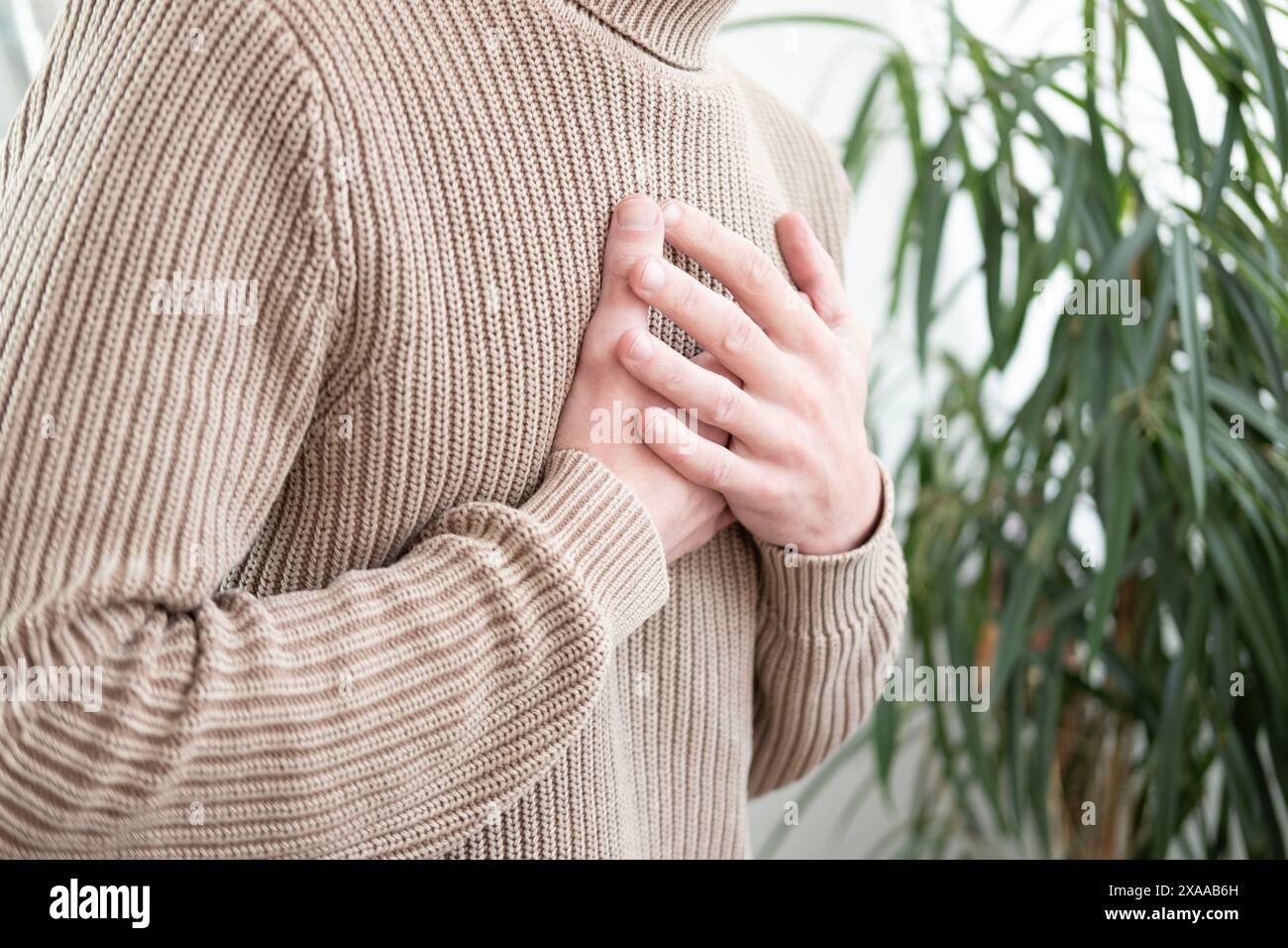 young man experiences experiences sudden chest pain behind sternum ...