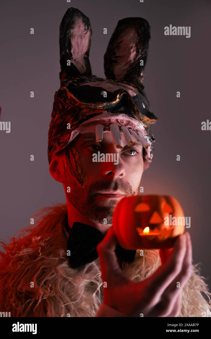 creepy hare man, young guy in cringe in scary bunny mask, holding ...