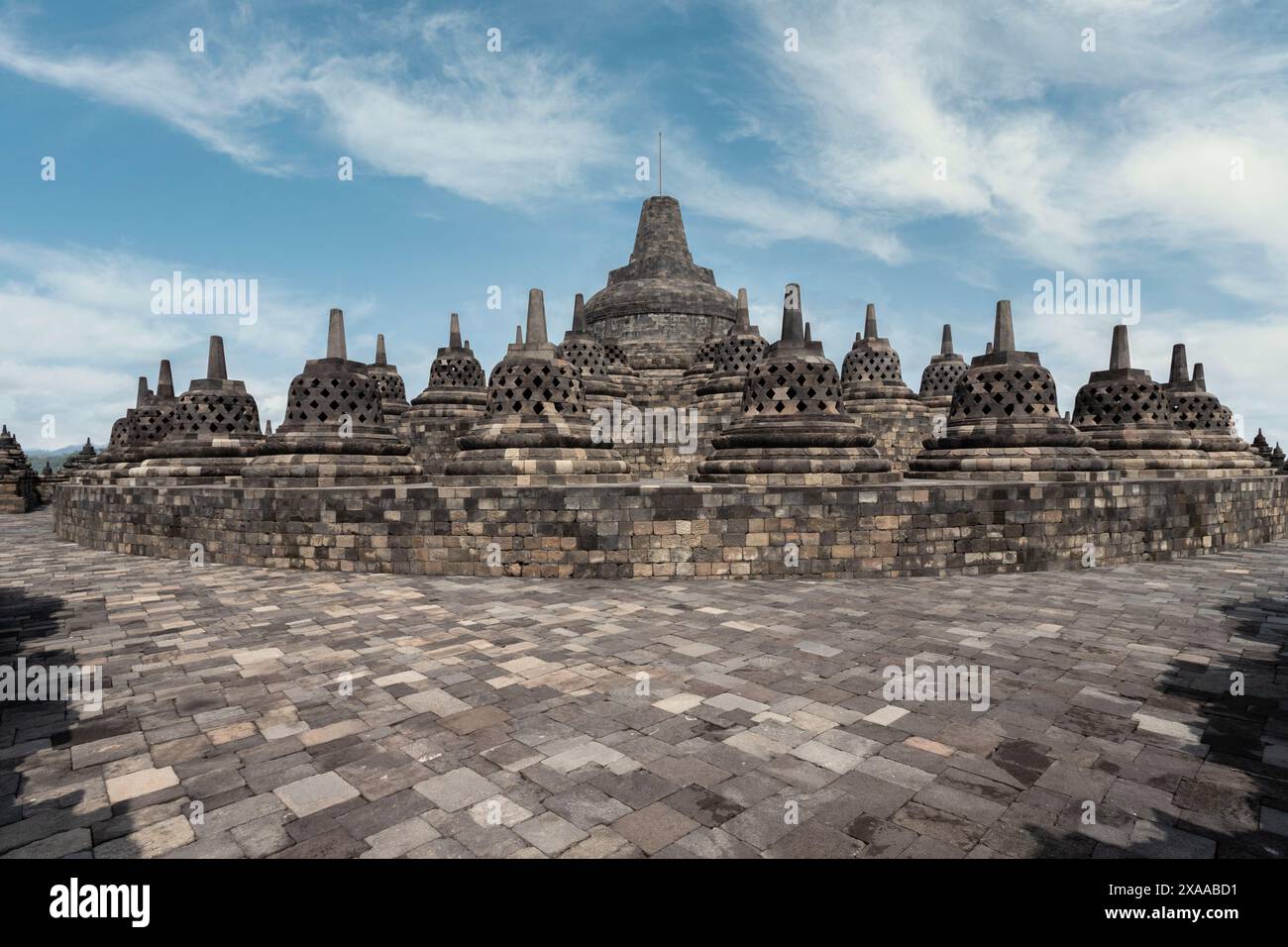 A stone building with spires, encased by bricks and small trees Stock ...