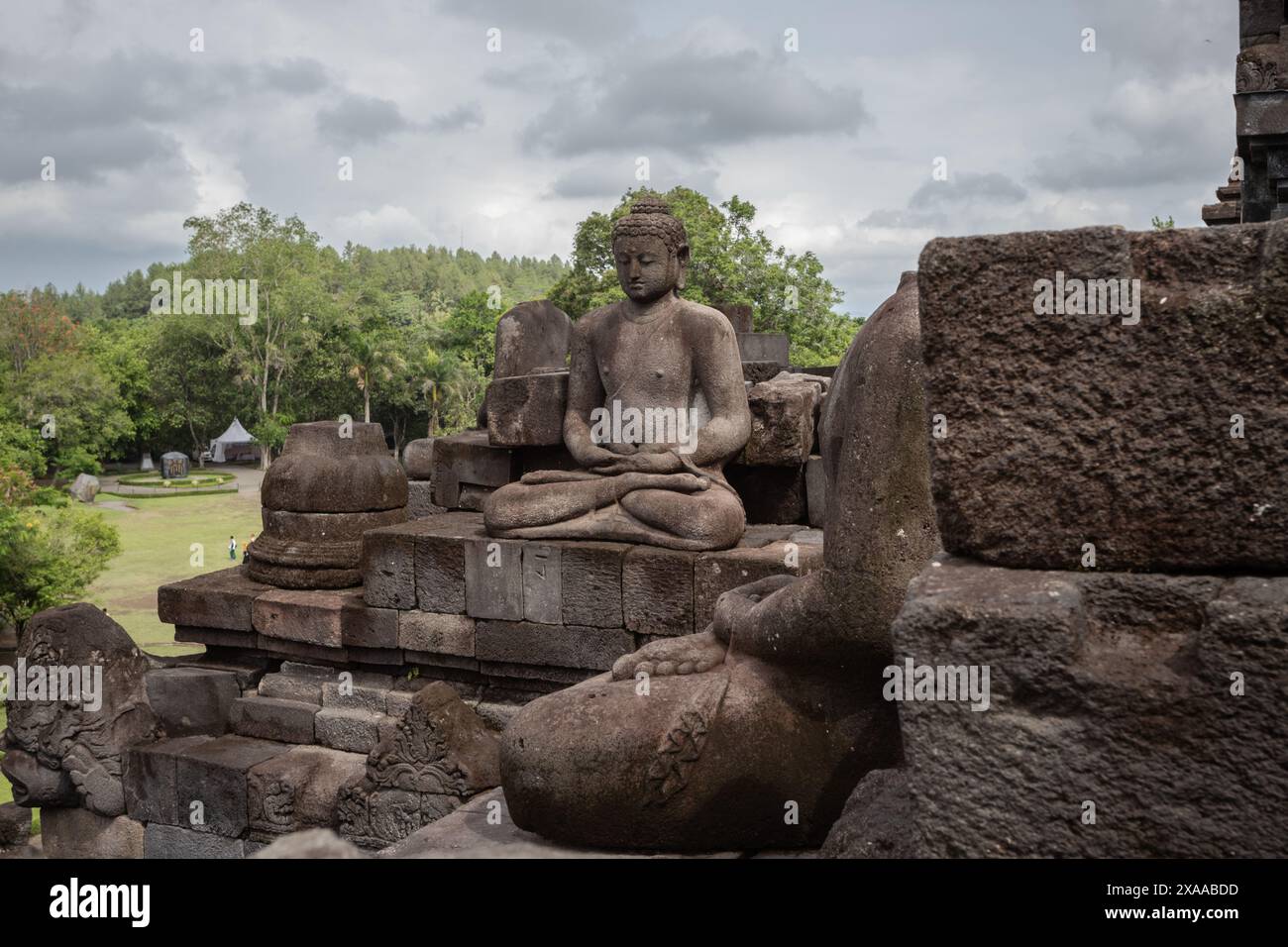A miniature figure of a man on a stone bench Stock Photo - Alamy