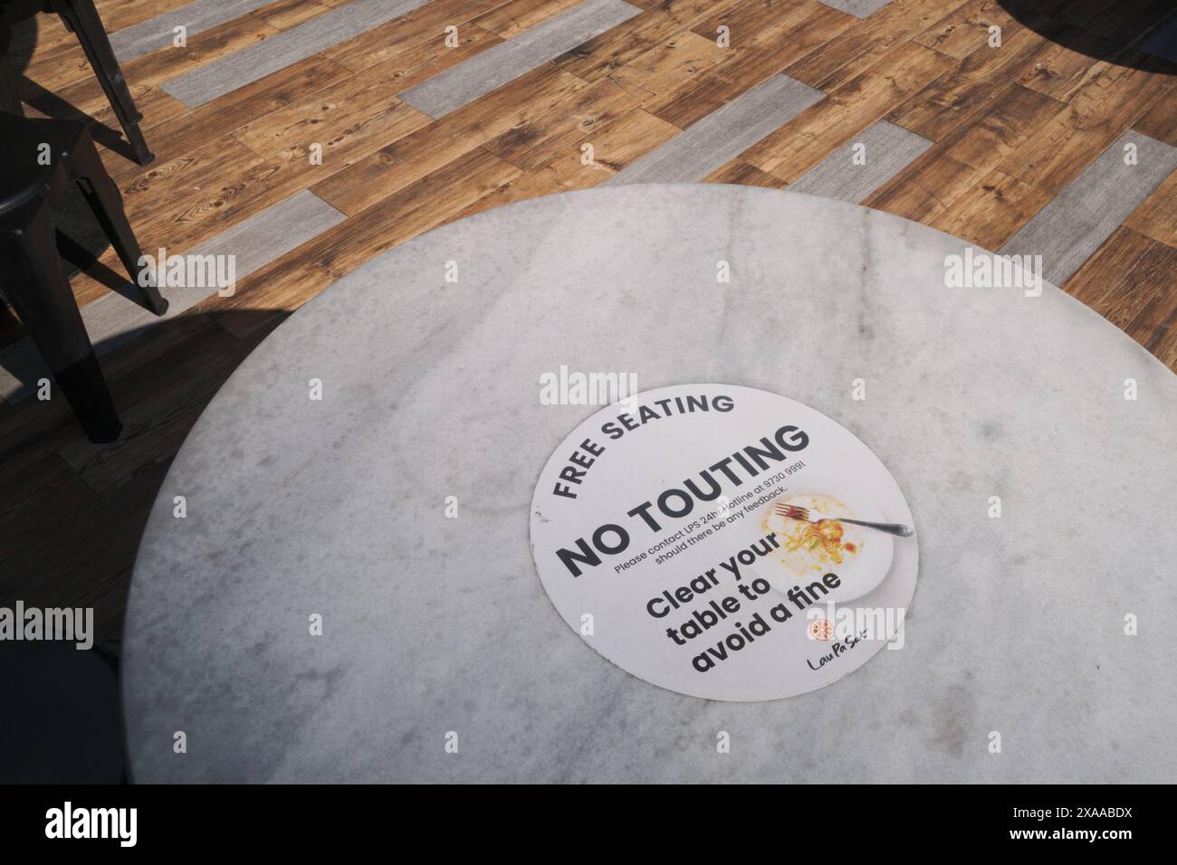 Signage on a street food market table ''free seating NO TOUTING clean ...