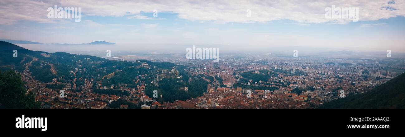 A city skyline with distant mountains and cloudy sky Stock Photo - Alamy