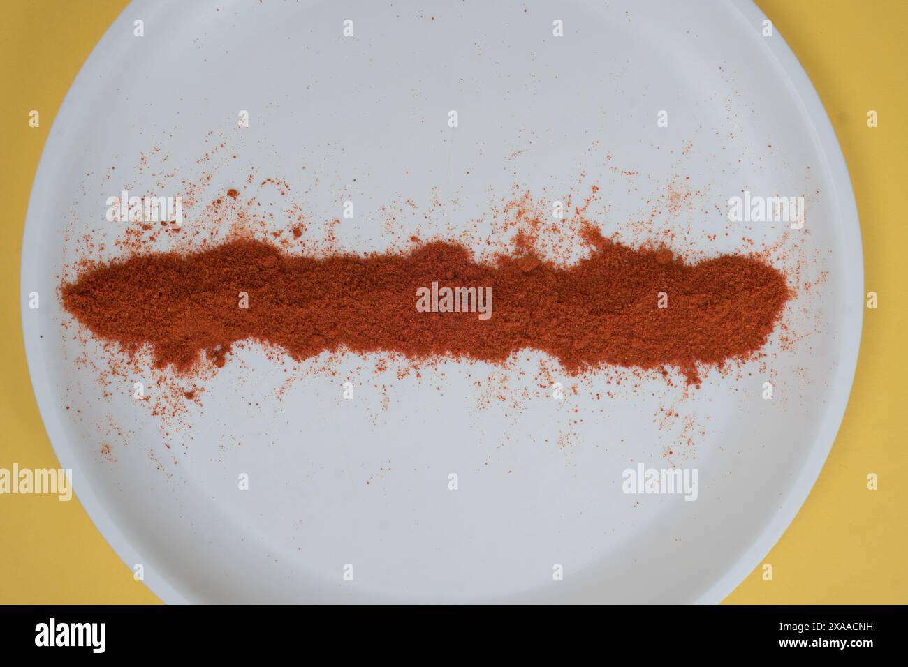 A scattering of red chili pepper powder on a white background Stock ...