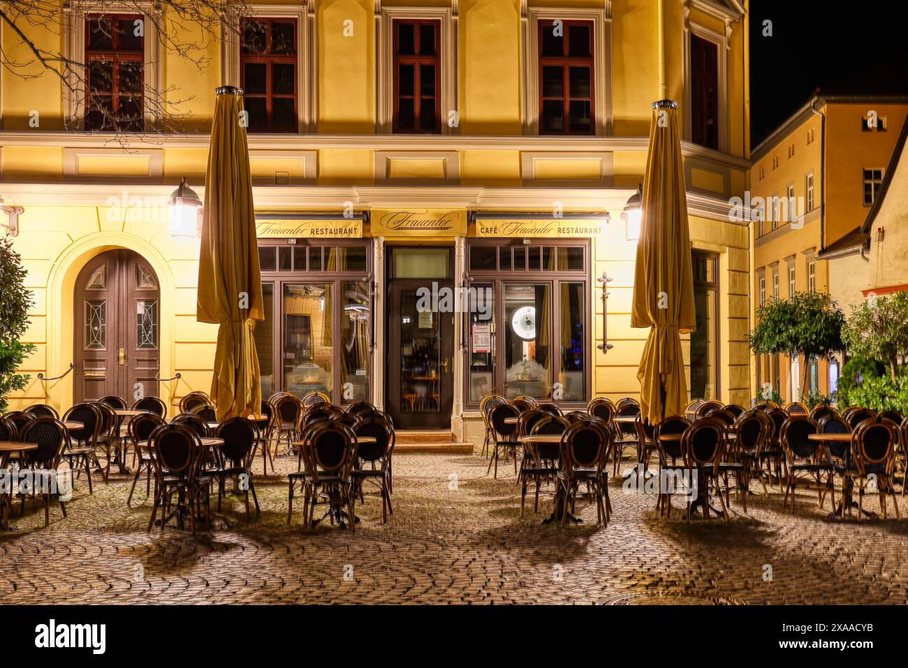 An outdoor dining area with tables and chairs set up outside a restaurant Stock Photo - Alamy
