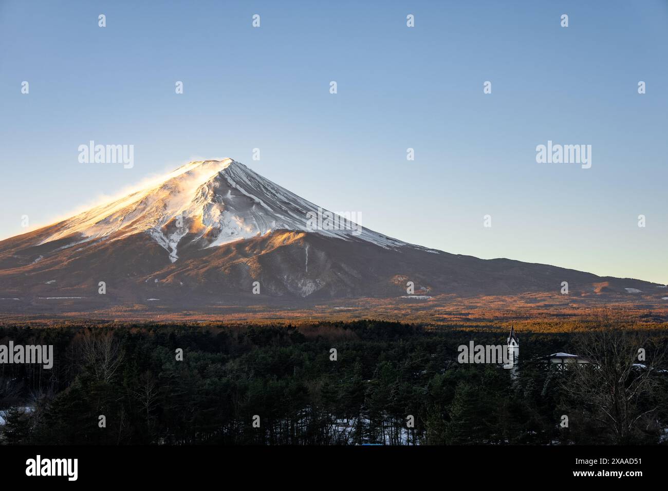 A morning view of Mount Fuji with a church steeple in the foreground in ...