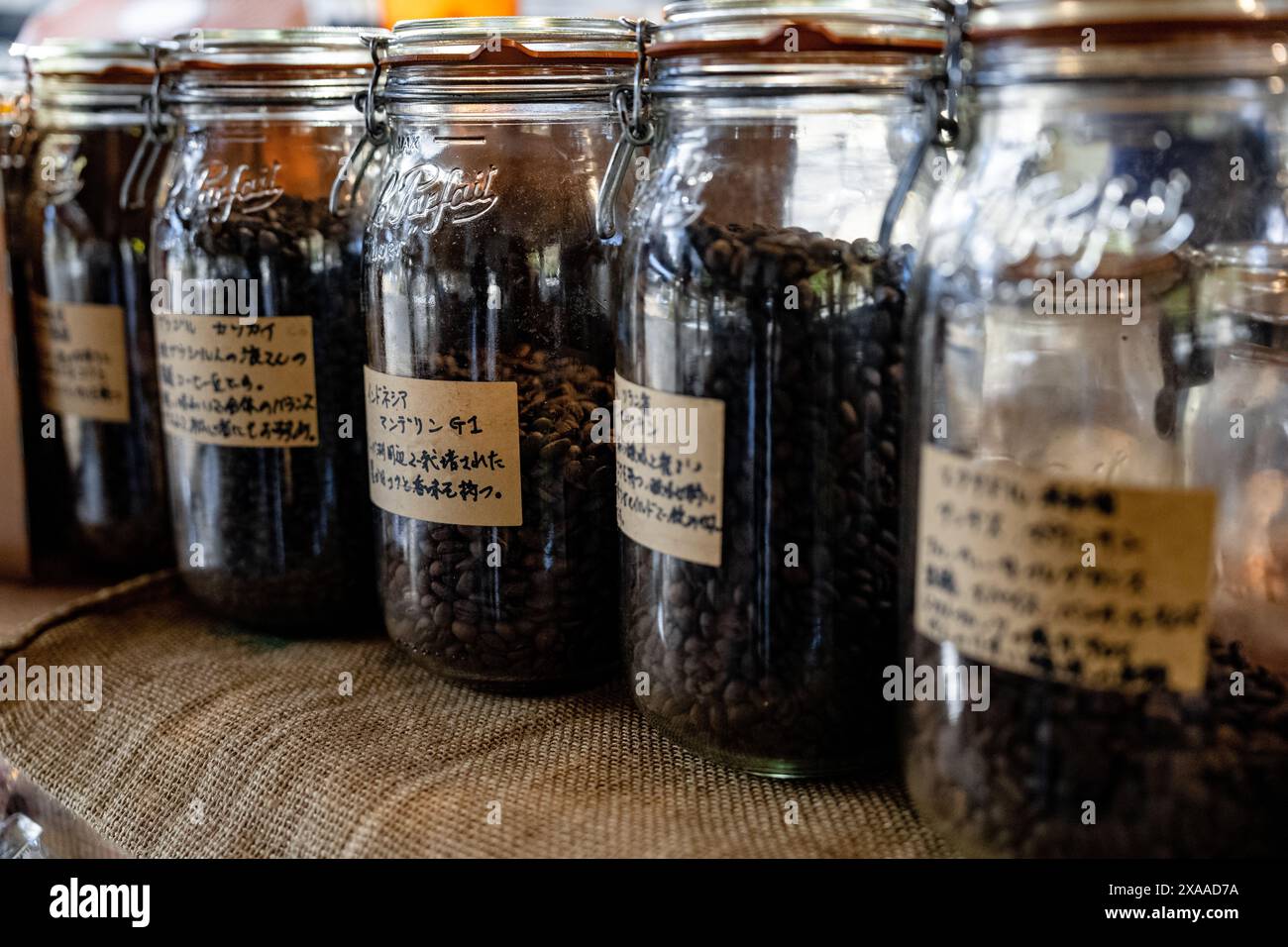 The glass jars filled with roasted coffee beans in a coffee shop in ...
