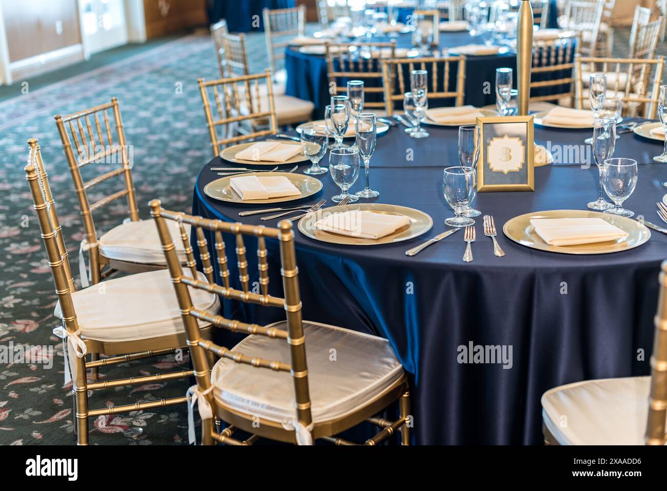 The tables are elegantly set with plates and silverware in a dining ...