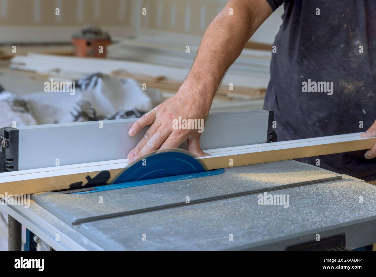 Electrically powered table saws are used to cut wood molding filler ...