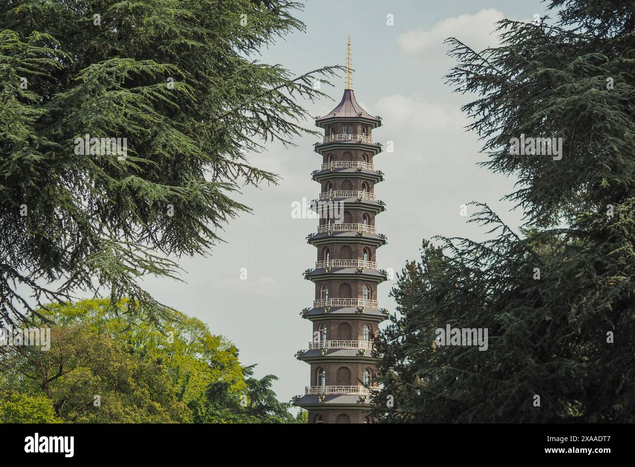 A Chinese tall tower rises above trees in a park setting Stock Photo ...