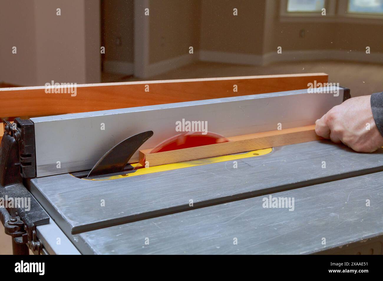 Cutting wood cabinet filler with an electric table saw Stock Photo - Alamy