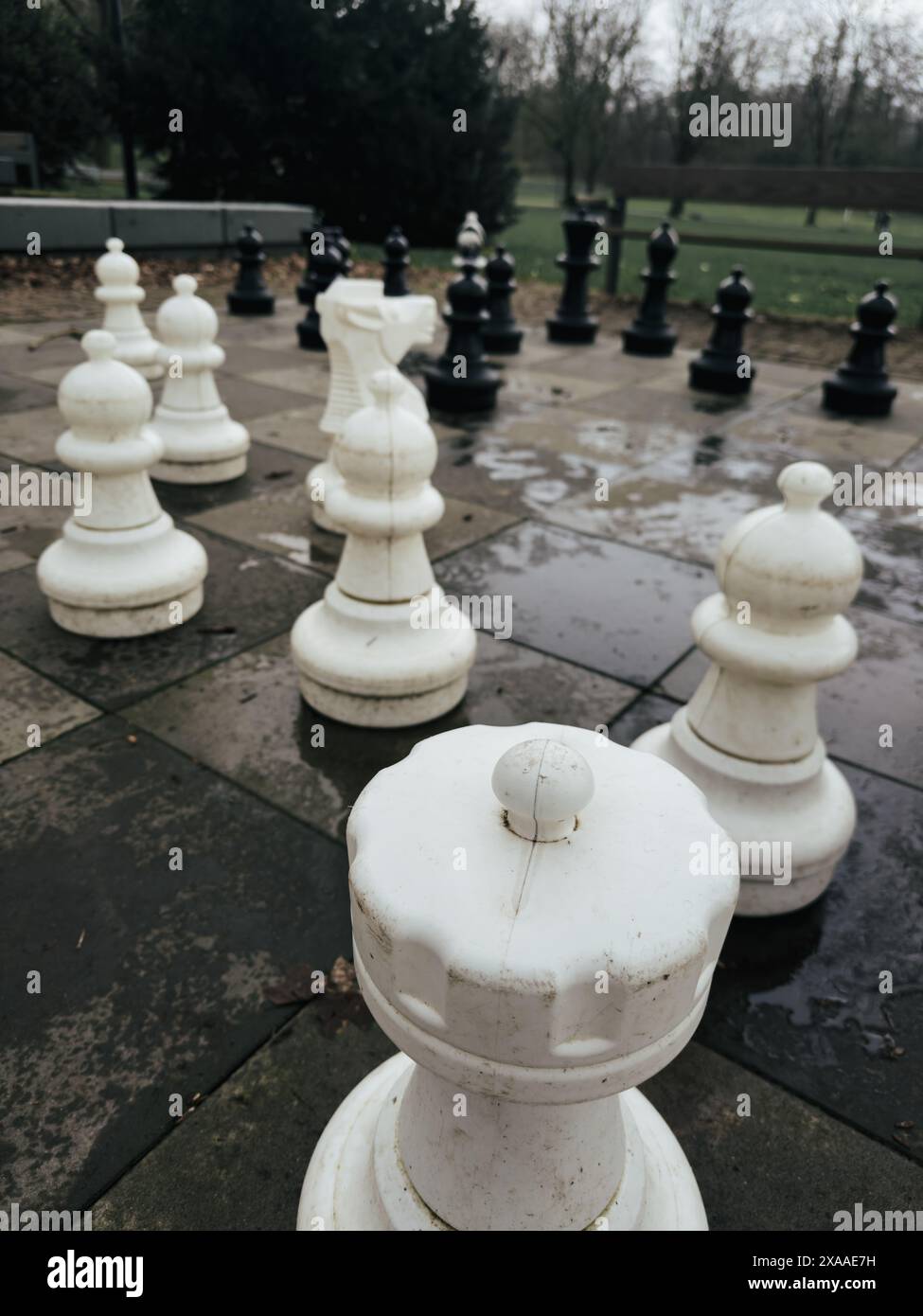 The chess pieces on a park floor, strategic game outdoors Stock Photo ...