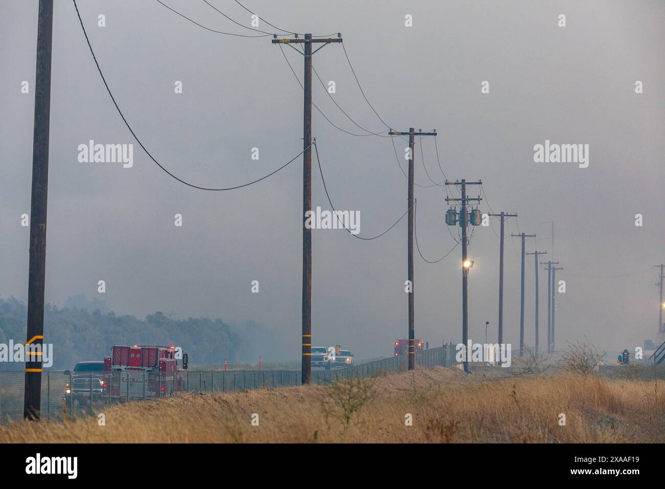 Cal Fire teams search for access to to spot fires behind a fenced ...
