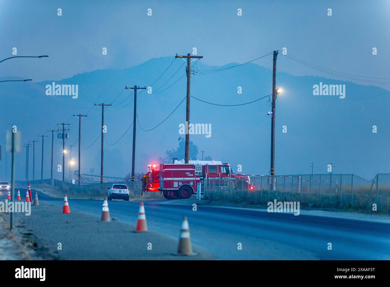 Cal Fire teams search for access to to spot fires behind a fenced ...