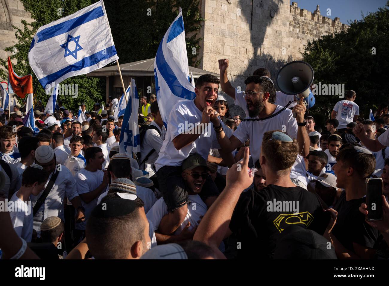Israelis shout slogans and wave national flags during a march marking ...