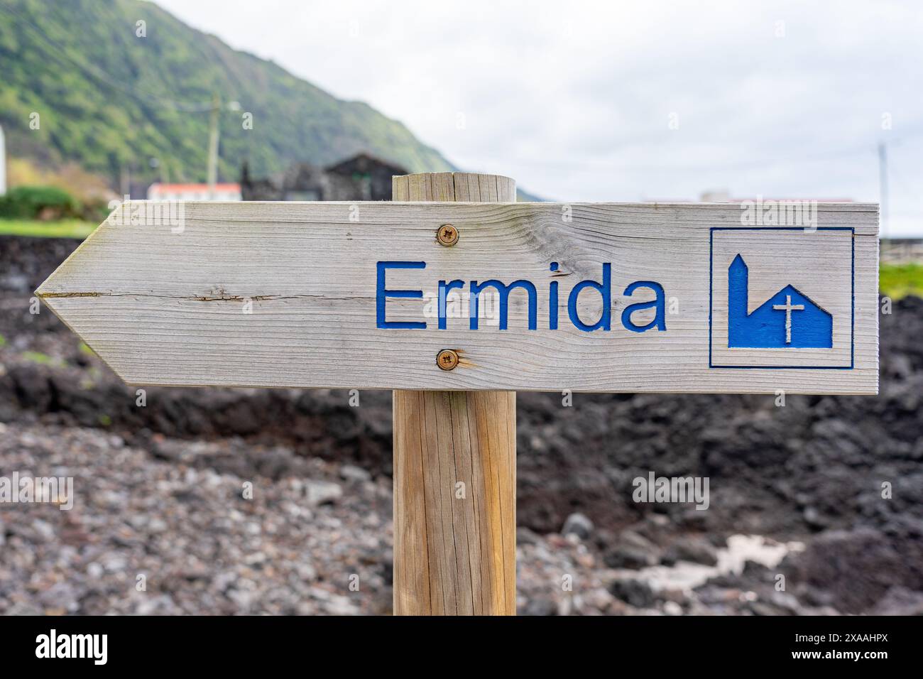 Pine wood hermitage direction sign with design of a church, fajã das ...