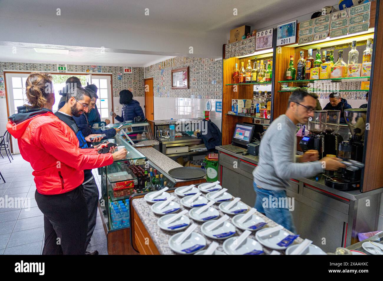 Interior of the Nunes café with customers standing and drinking coffee ...