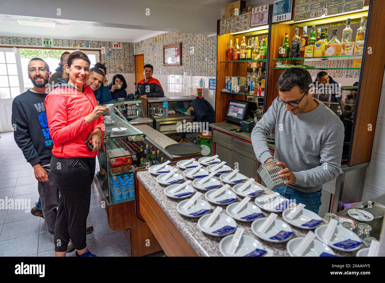Interior of the Nunes café with customers standing and drinking coffee ...