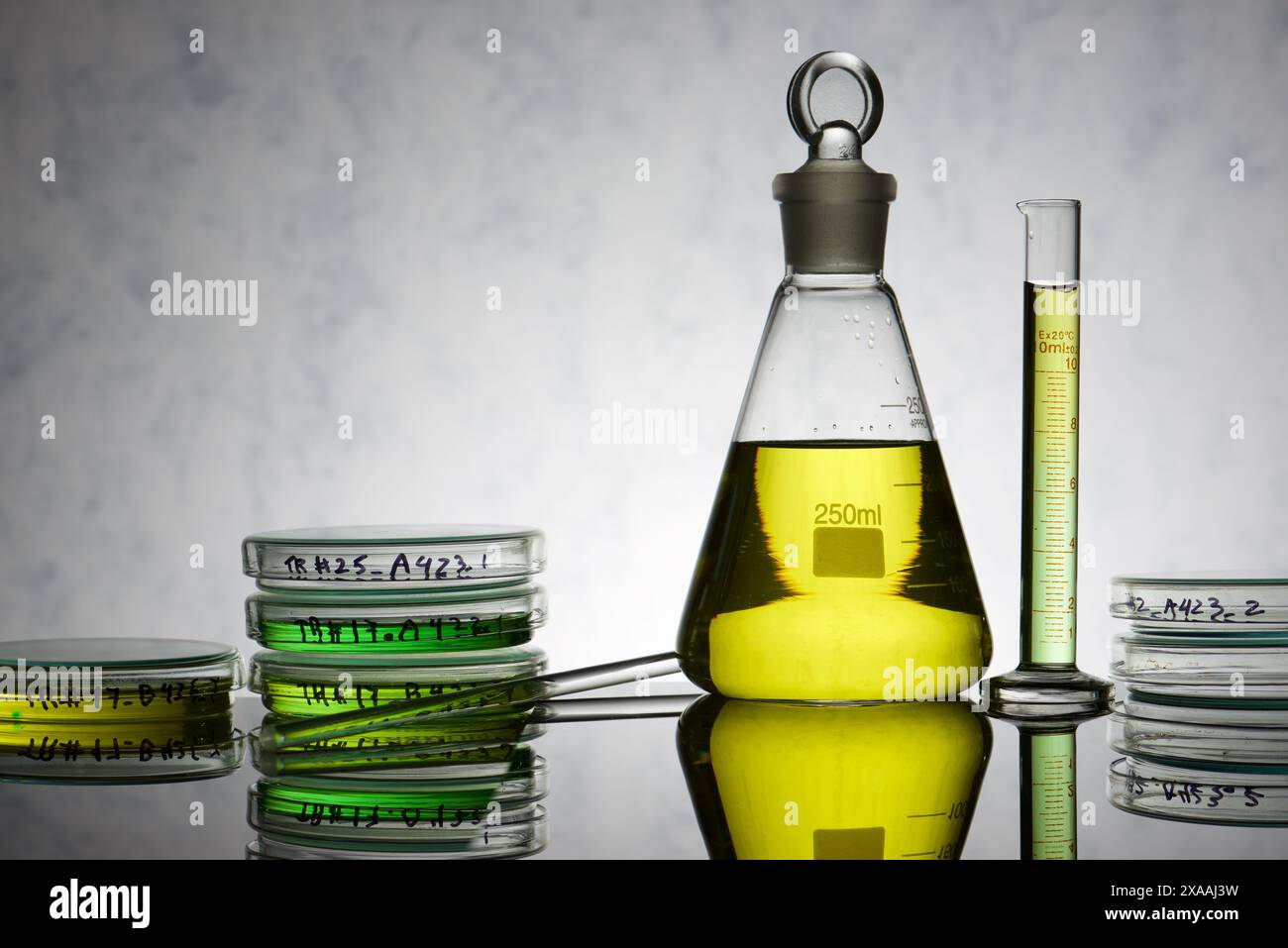 Laboratory containers with yellow and green liquid standing on a ...