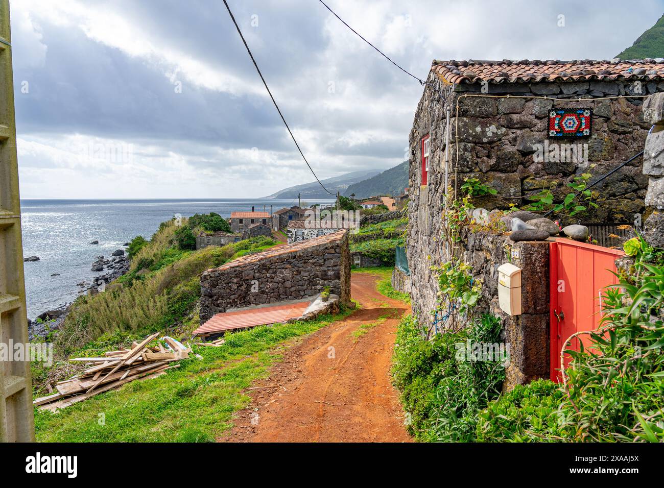 Landscaped coastal area with typical stone houses in Fajã dos ...