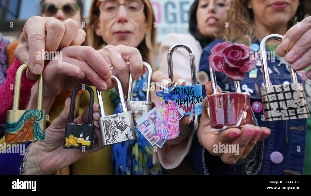 International artists pose with padlocks they created to show ...