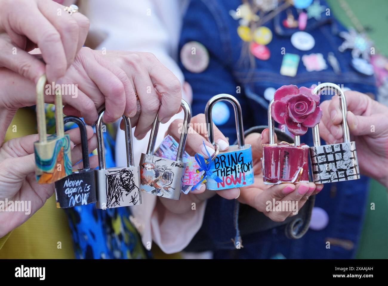 International artists pose with padlocks they created to show ...