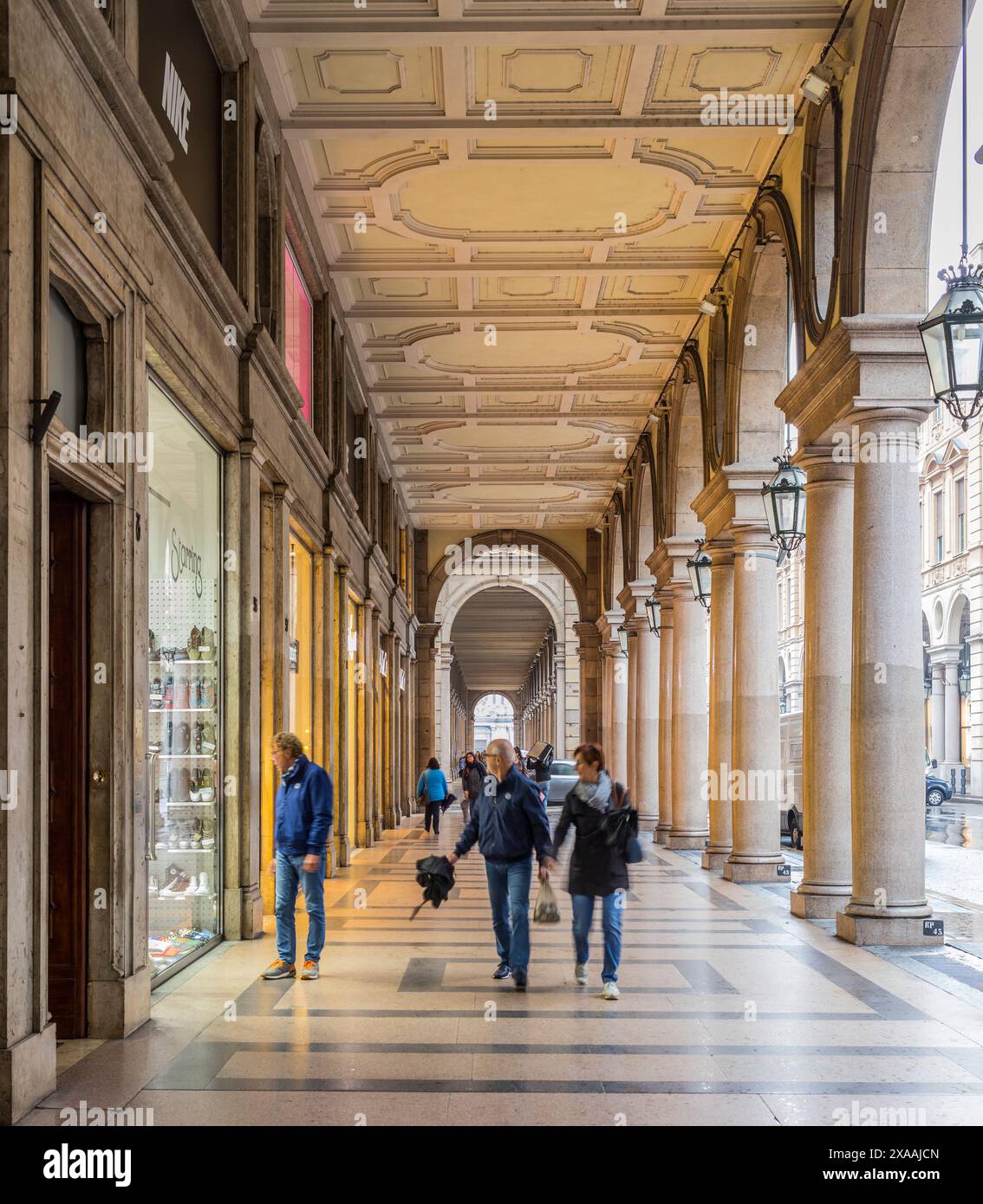 Turin, Italy - October 15, 2019: People strolling under the arcades of ...
