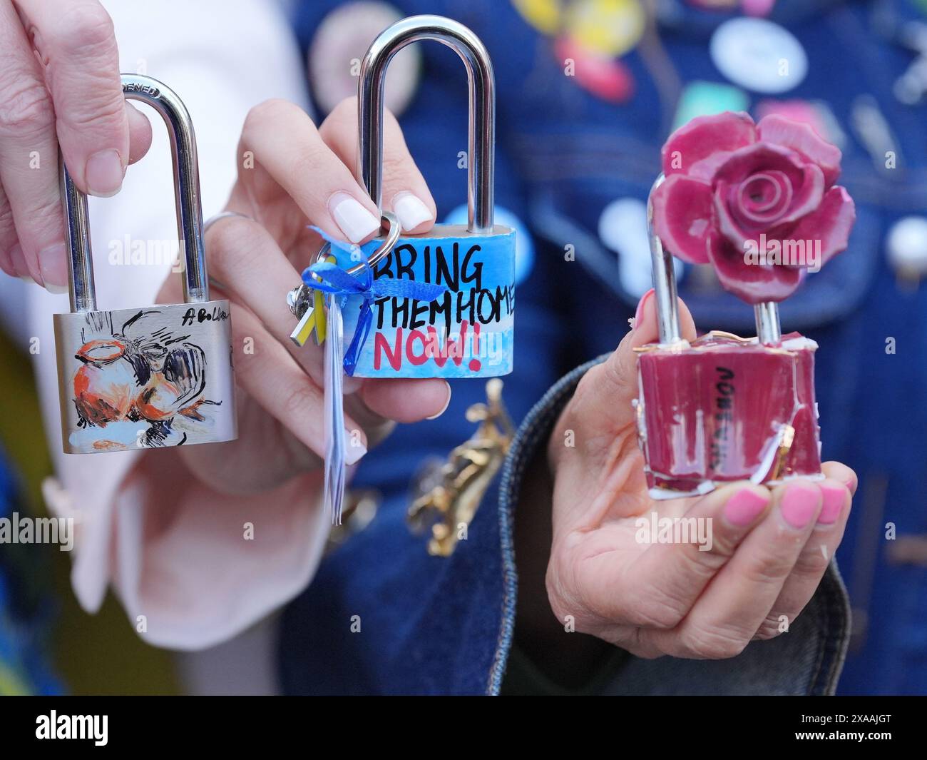 International artists pose with padlocks they created to show ...