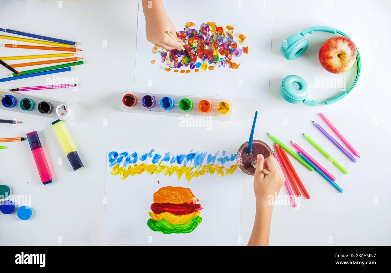 Drawing on a white sheet of paper. Creativity and art. Hands paint ...