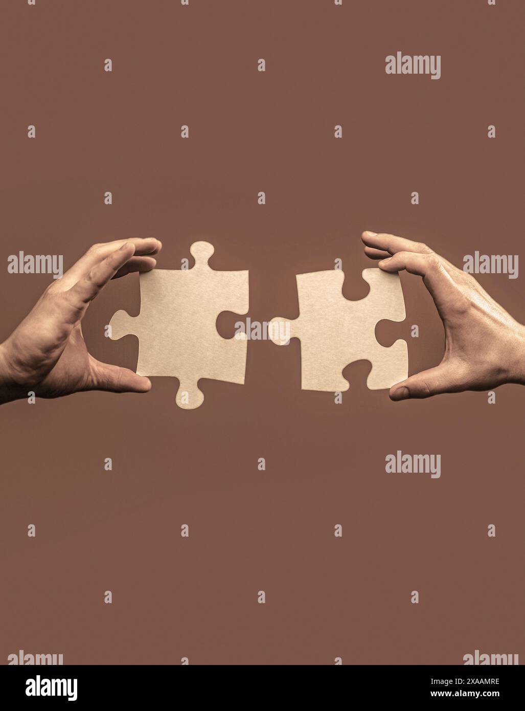 Closeup hand of connecting jigsaw puzzle. Men holding and putting a ...