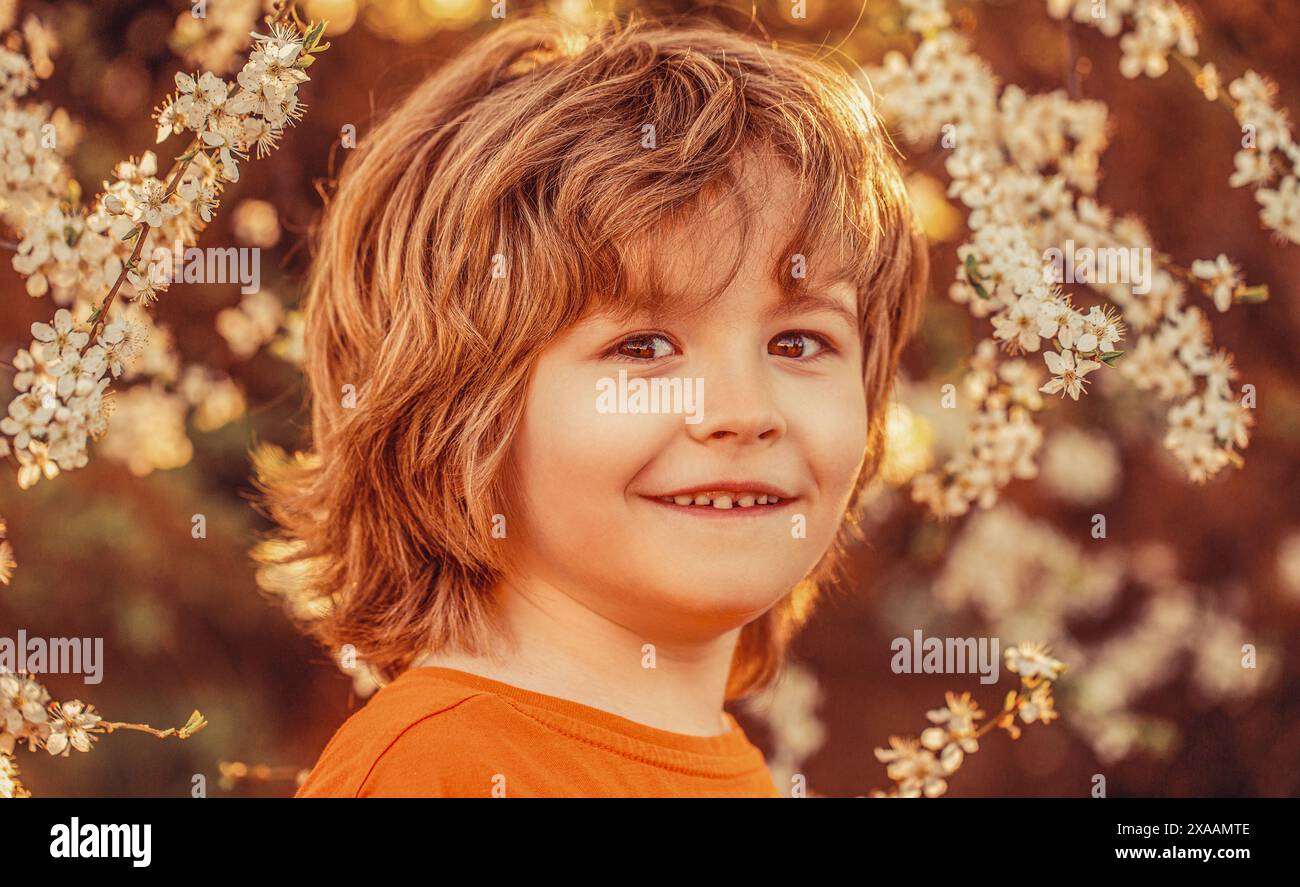 Child, boy, spring, sun. Happy little boy walking in spring garden ...