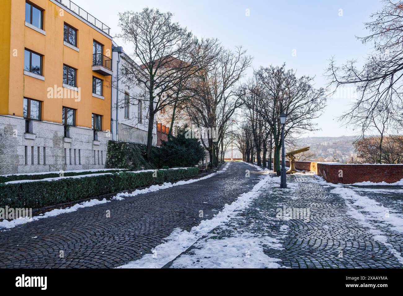 Buda Castle with buildings next to cobblestone pathway in winter with ...