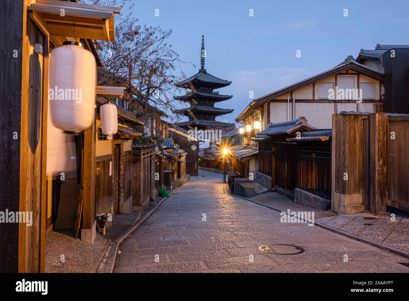 Traditional Hokan-ji Gojunoto Pagoda towering over narrow city street ...